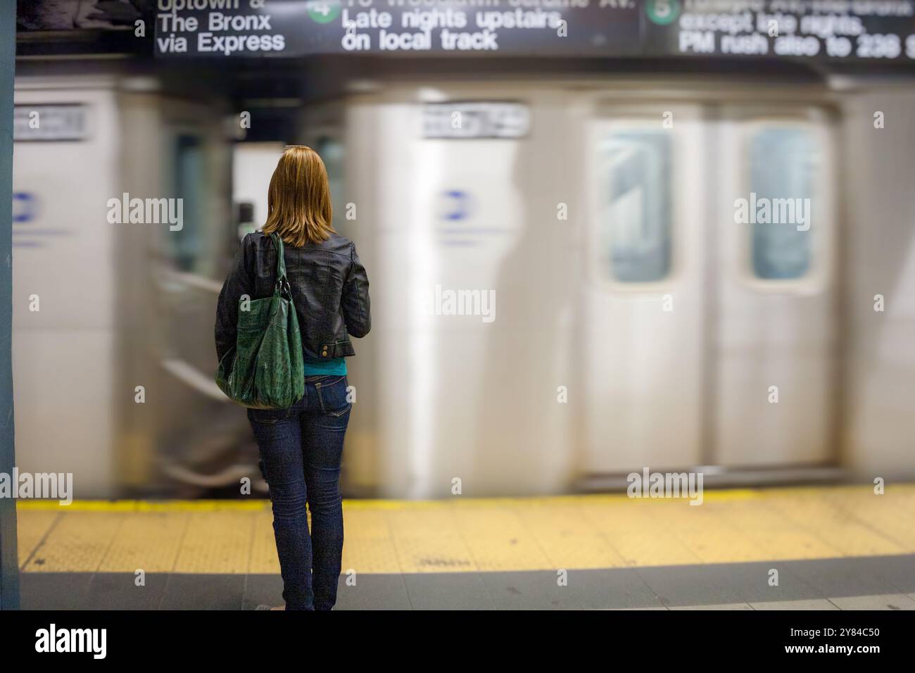 Waiting for the train, New York City: Young women stand on the subway ...