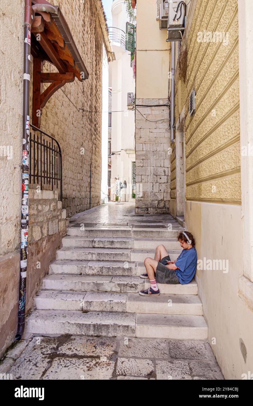 Split Croatia,Old Town,teen boy sitting,steps narrow pedestrian street ...