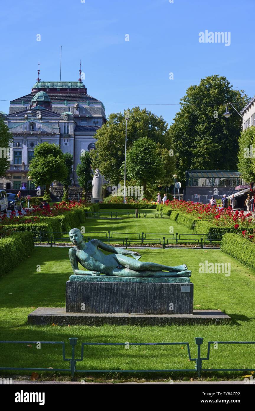 Lying poet statue in front of a historic building and sunny weather ...