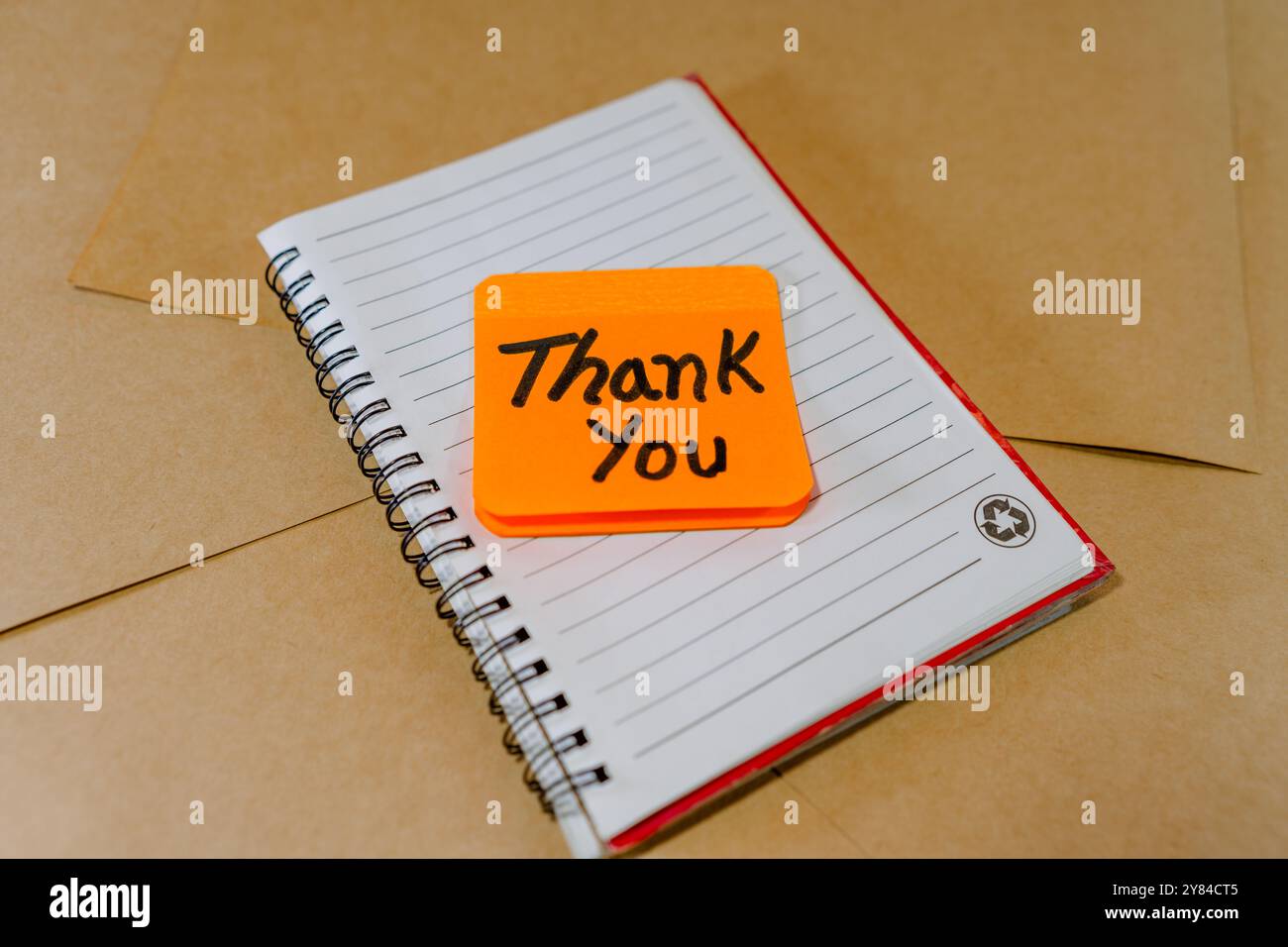 Thank you phrase written on recycled cardboard with a background of a ...