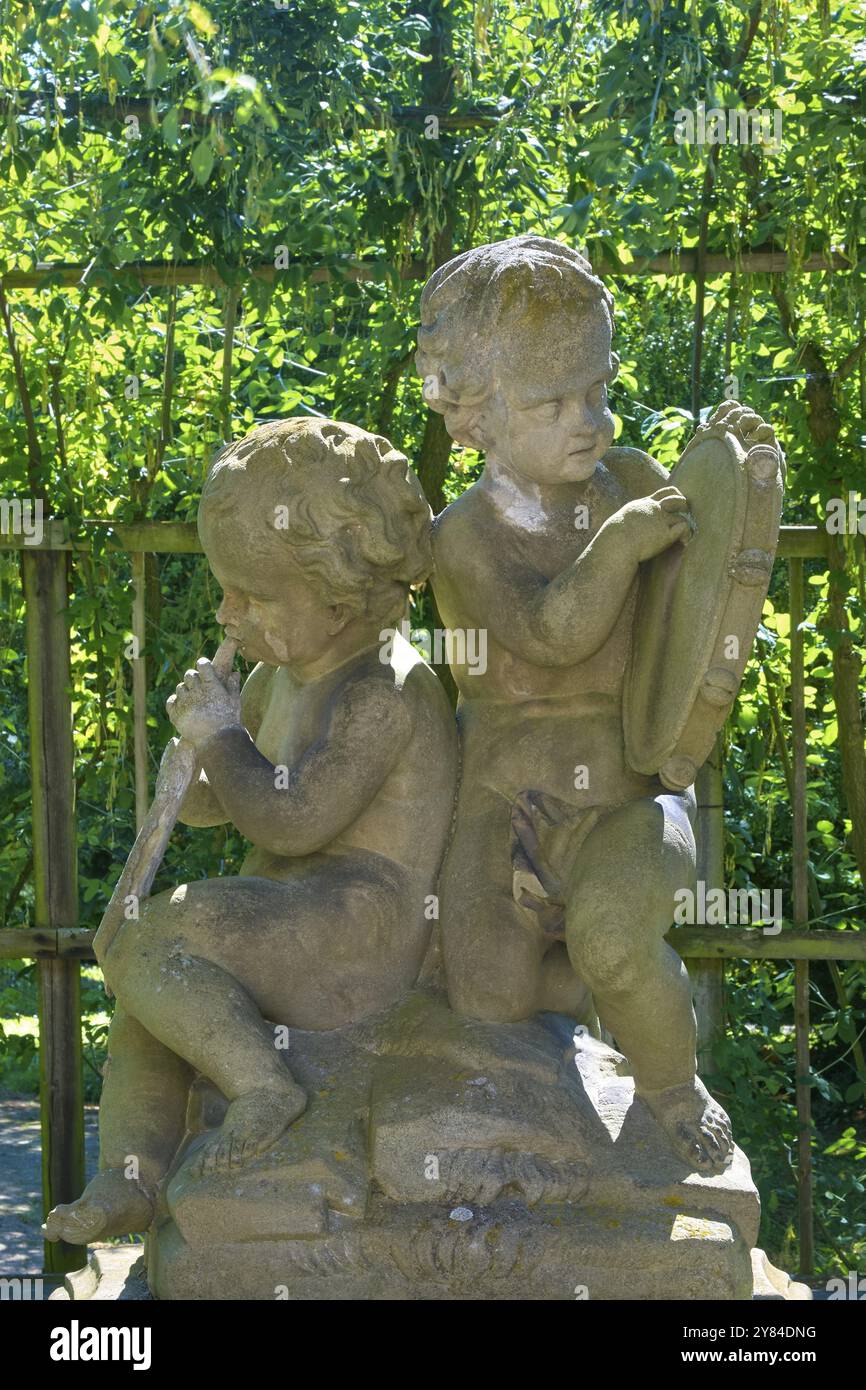 Stone statue, Buten, angel, of two children playing musical instruments ...