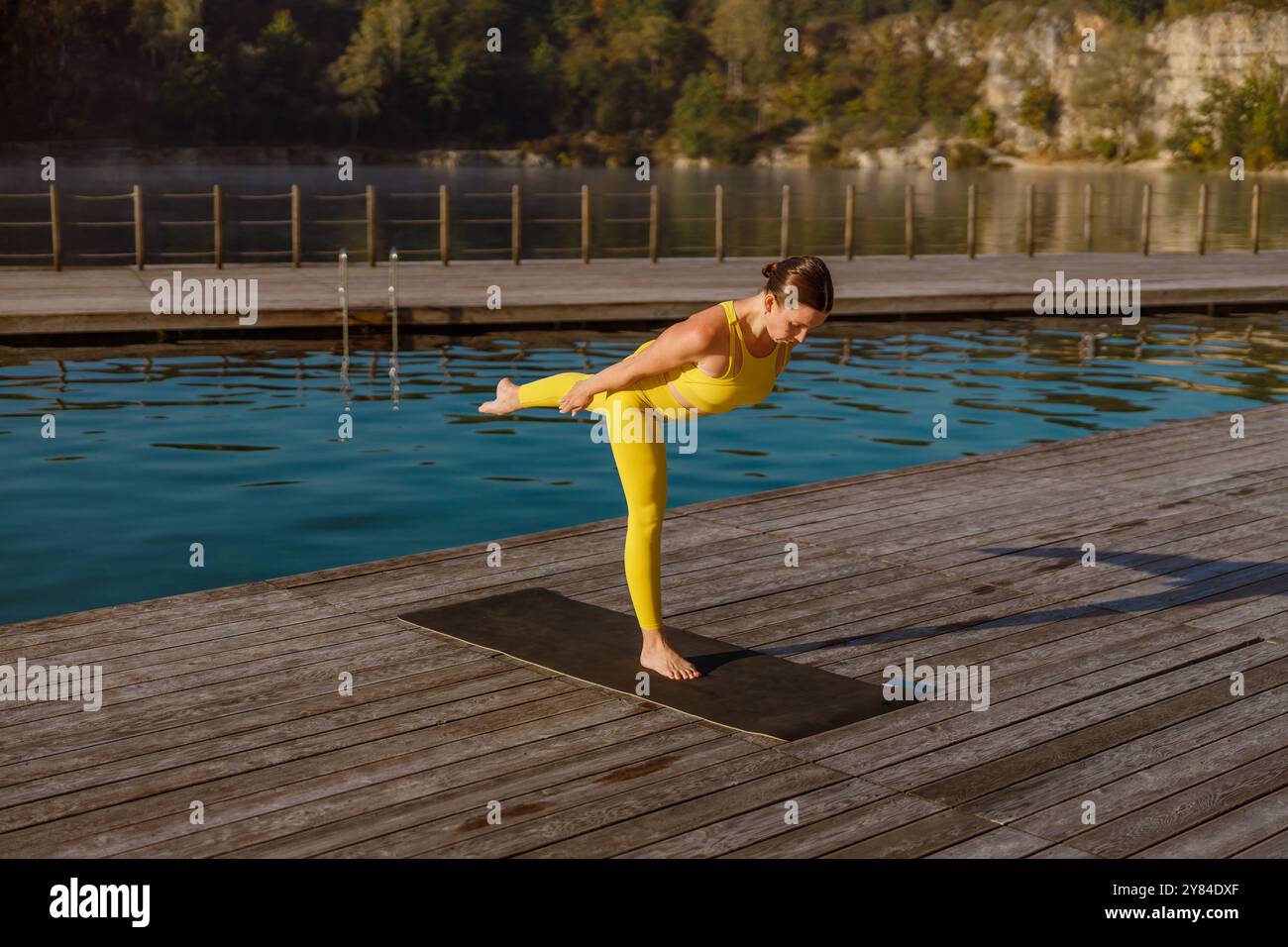 Experience a Serene Yoga Pose by the Water while dressed elegantly in ...