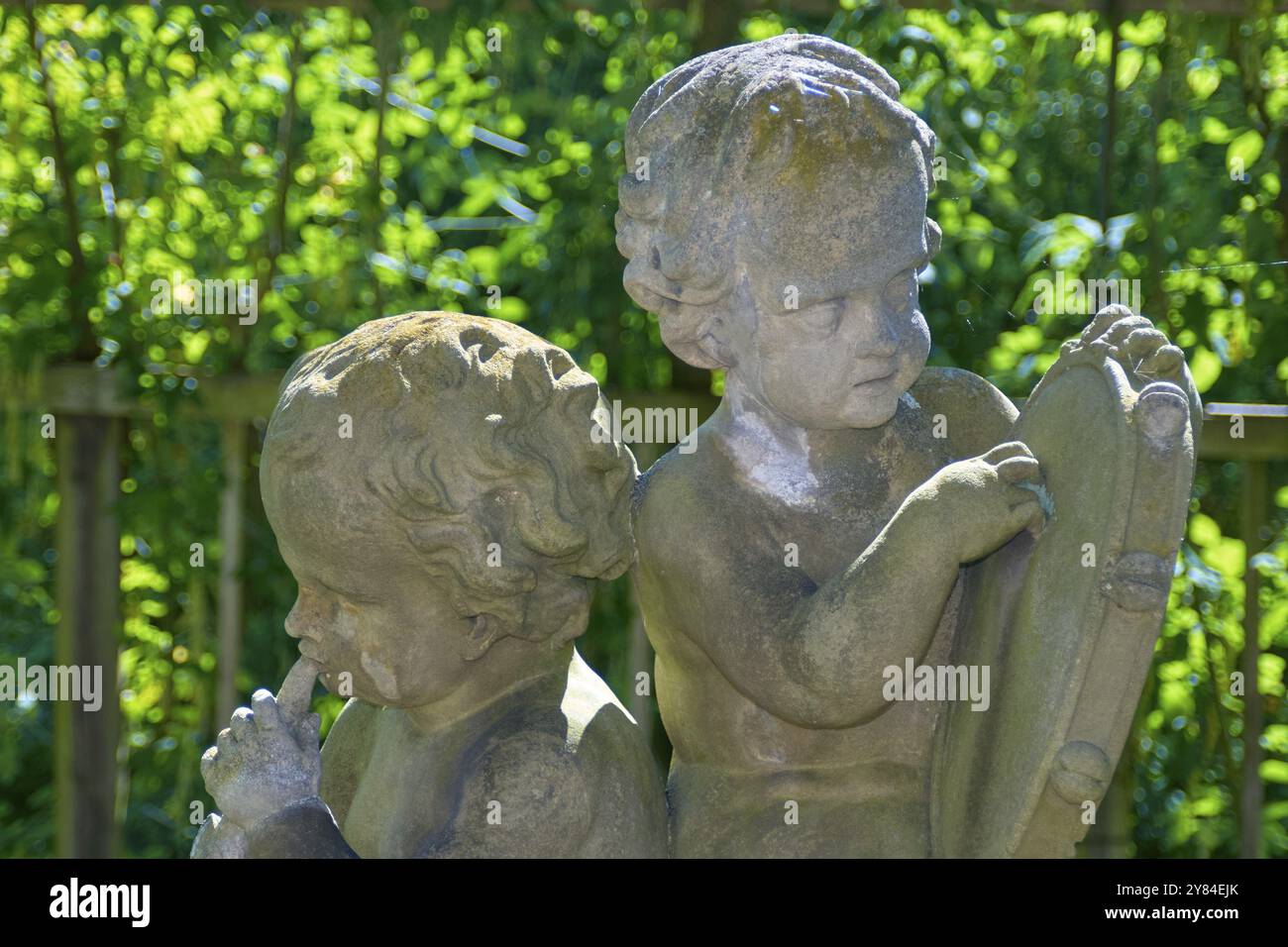 Stone statue, Buten, angel, of two children playing musical instruments ...