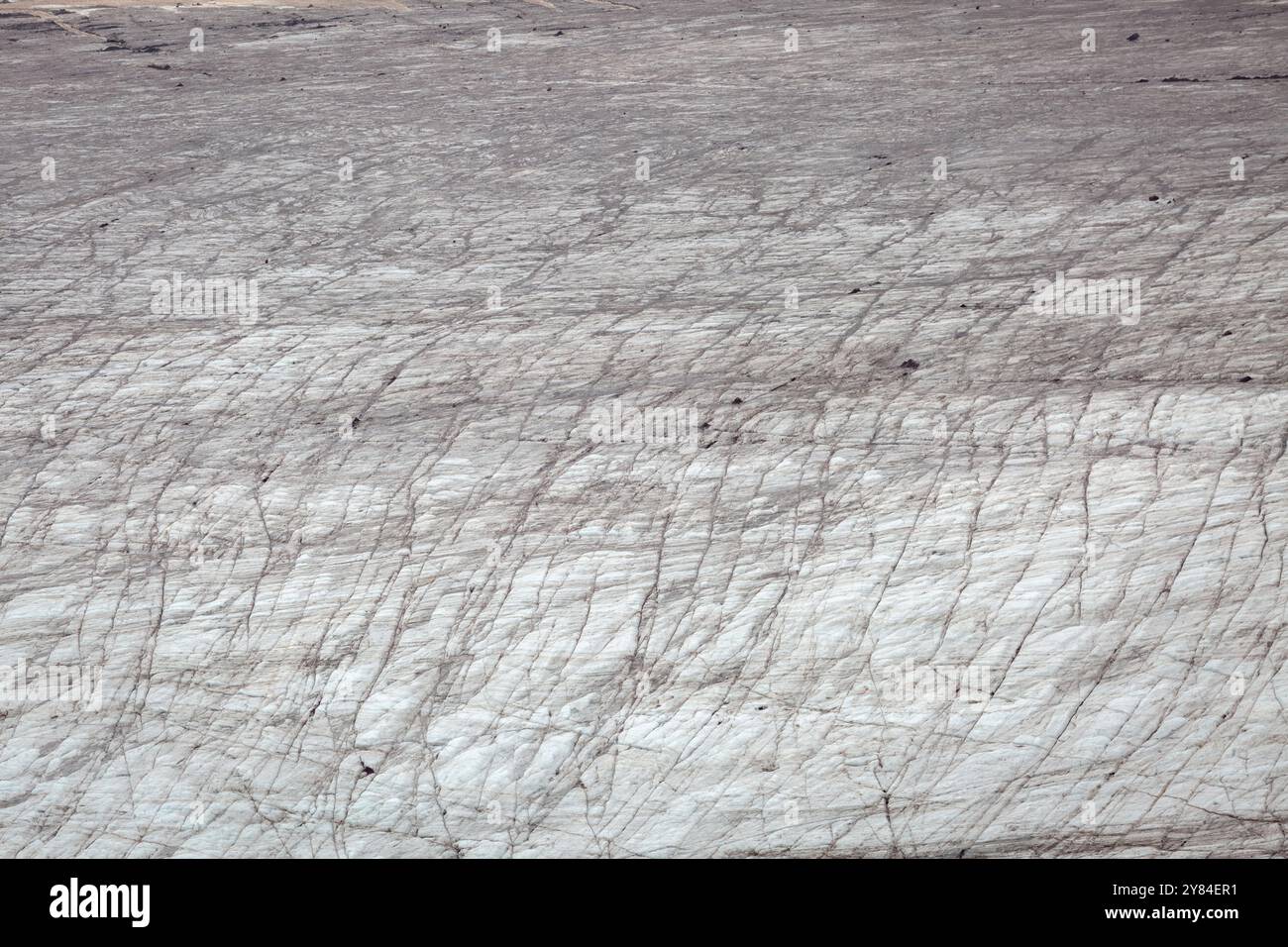 The glacier's icy formations resemble abstract sculptures. A vast ...