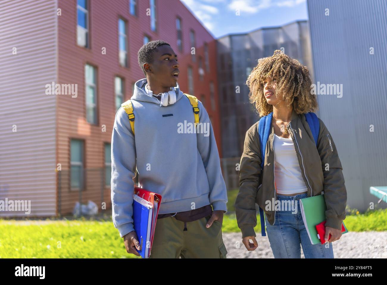 Diverse millennial students outside the university campus standing ...