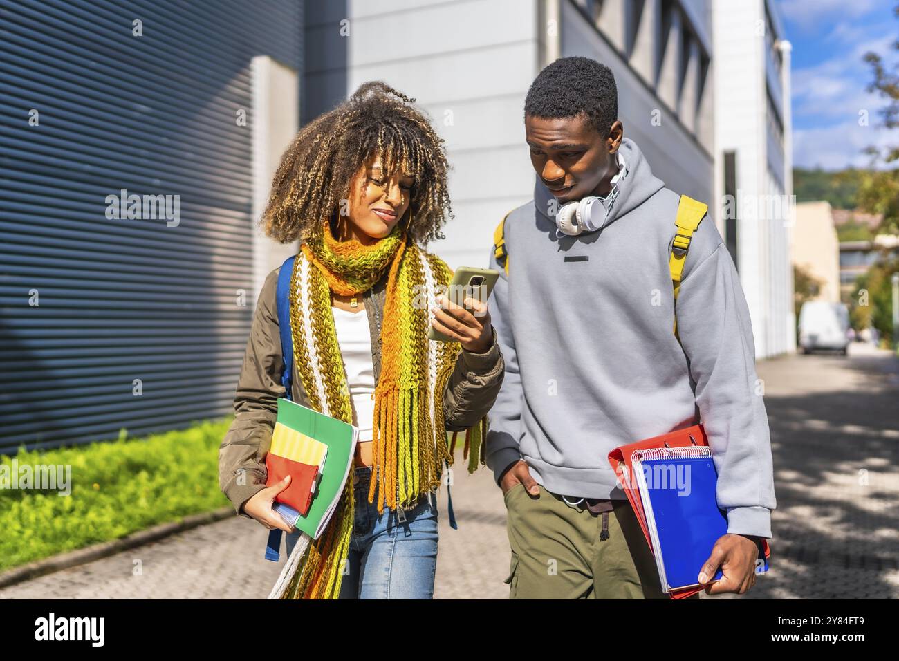 Multi-ethnic students checking information with the mobile phone ...