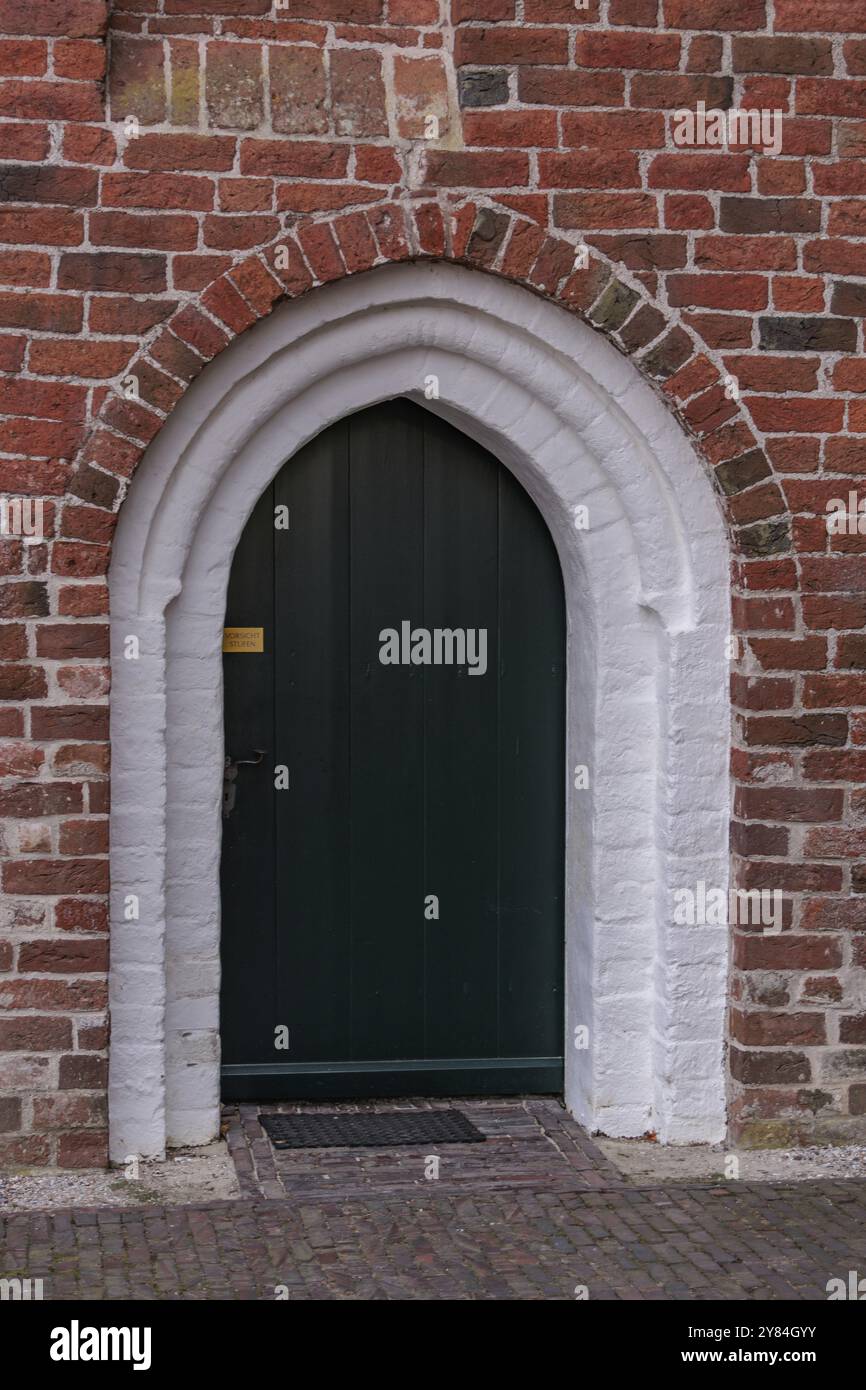 Gothic door in a brick building with a white arched frame, krummhoern ...