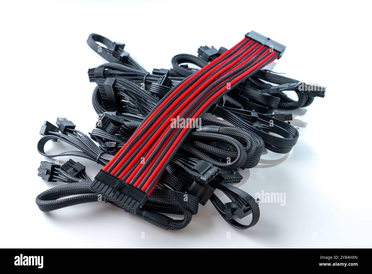 A black and red computer cable on a white background. This flexible ...
