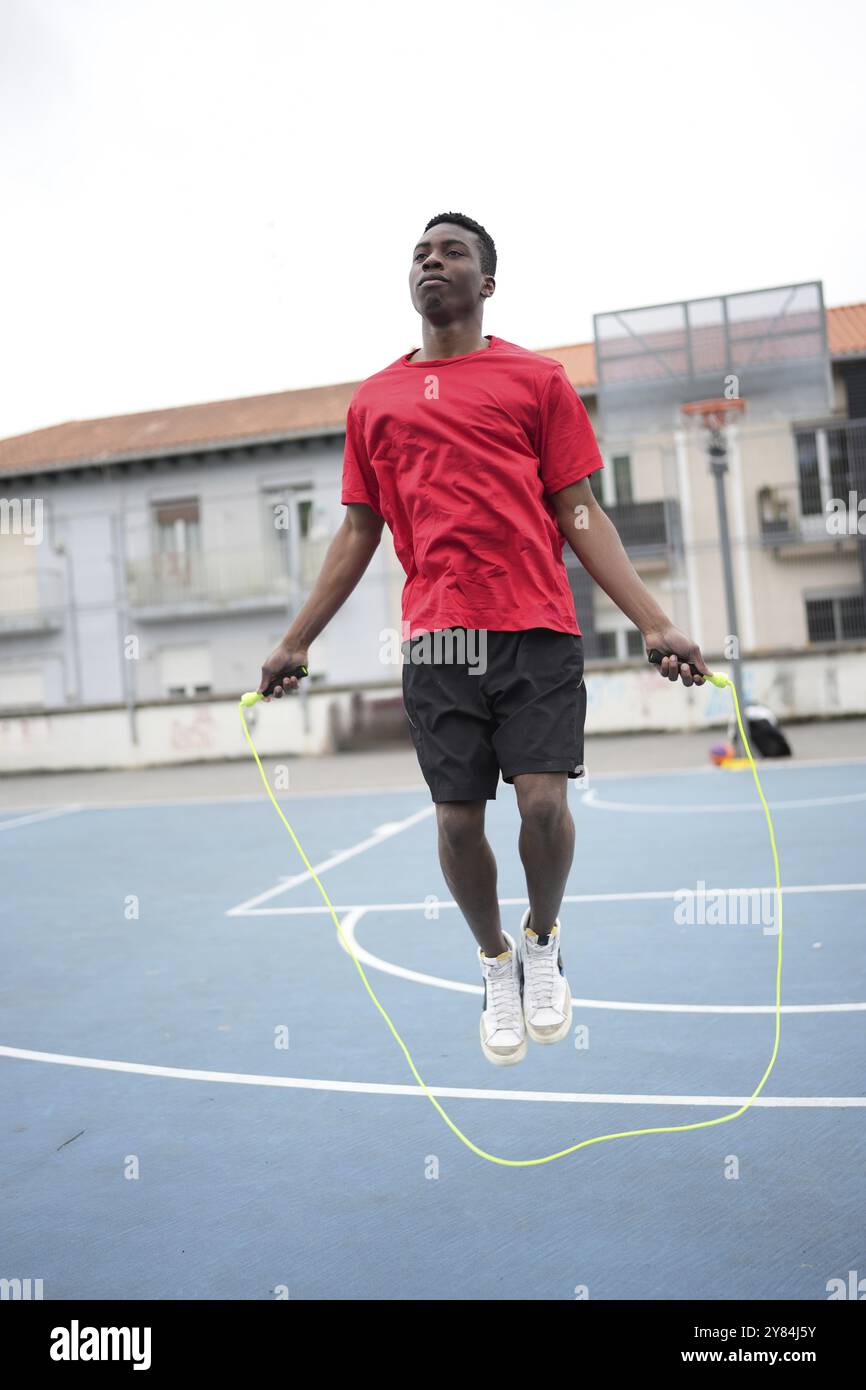 Vertical photo with motion of a young male african basketball player ...