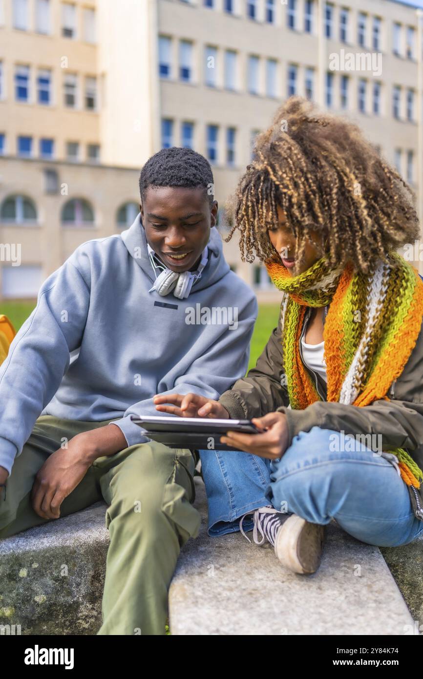 Millennial diverse student friends studying for an exam using digital ...