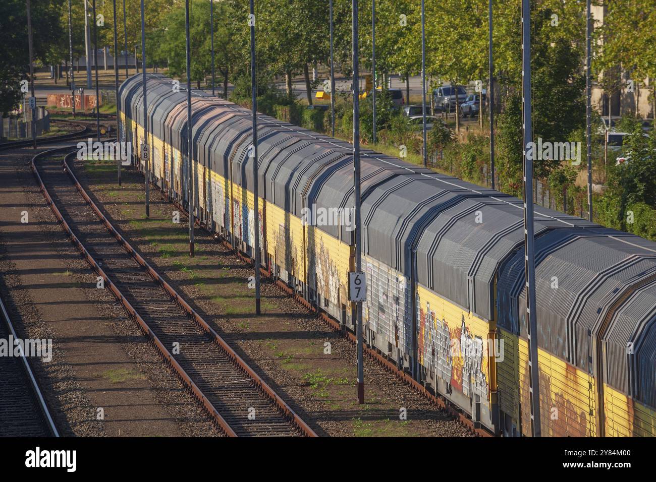 Colourfully painted goods train with freight wagons from a bird's eye ...