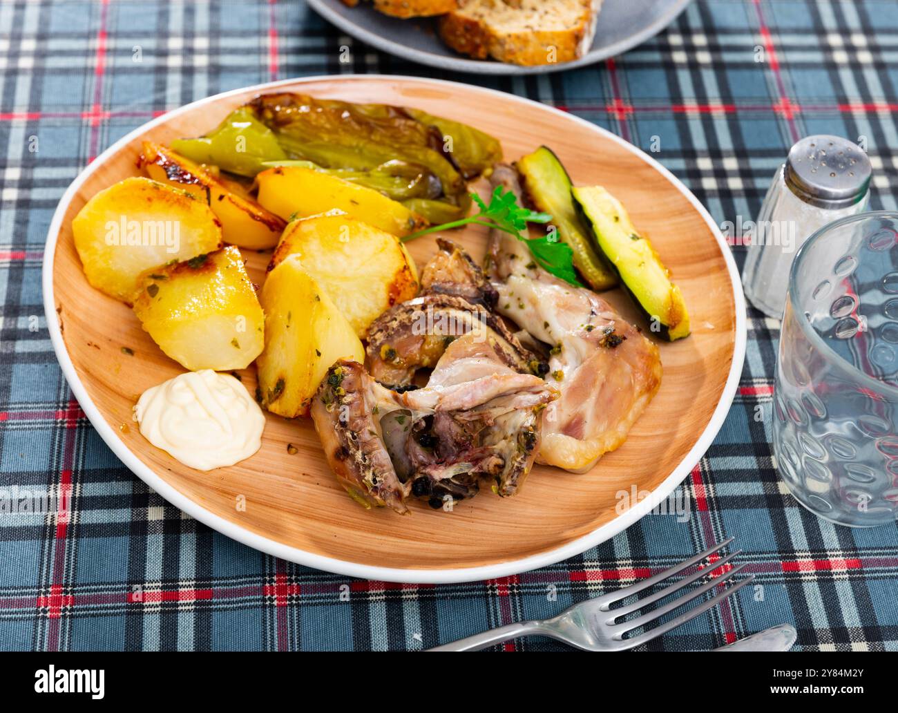 Roasted rabbit served with vegetable garnish Stock Photo - Alamy