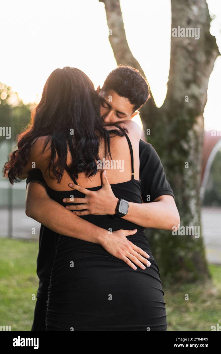 young latin couple hugging each other very much in love with closed ...