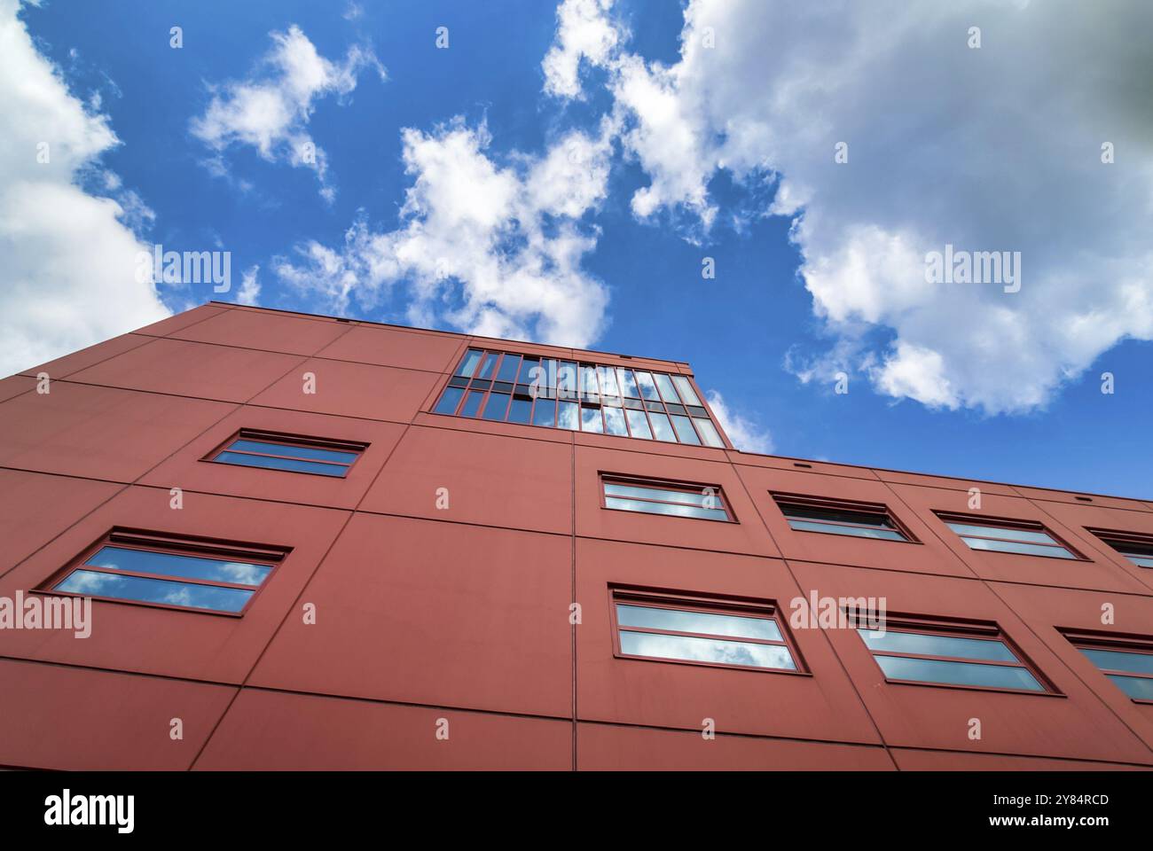 Red house facade with reflective windows Stock Photo - Alamy