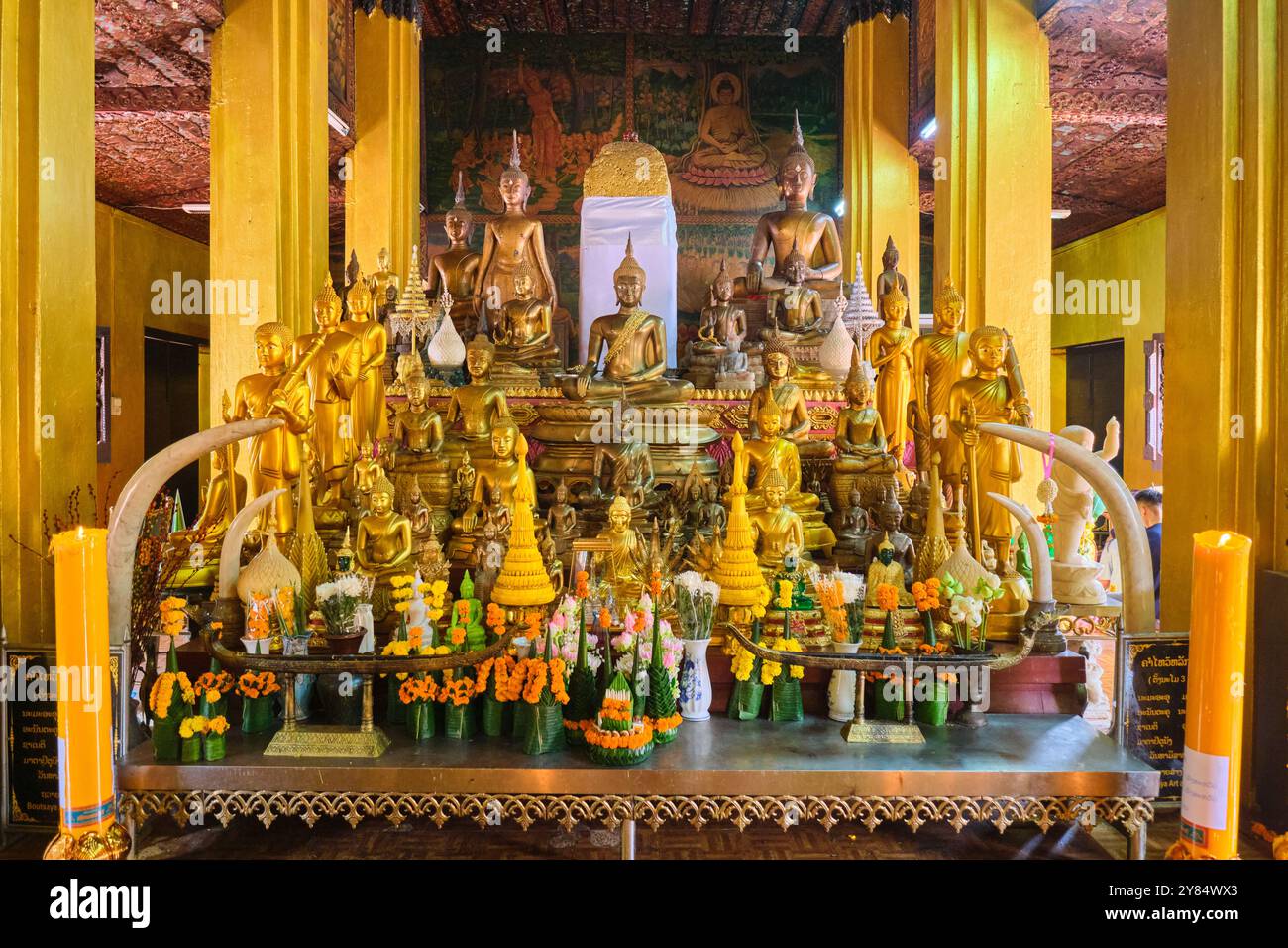 The fancy, gold, sitting Buddha, crammed main altar. At Wat Si Muang ...