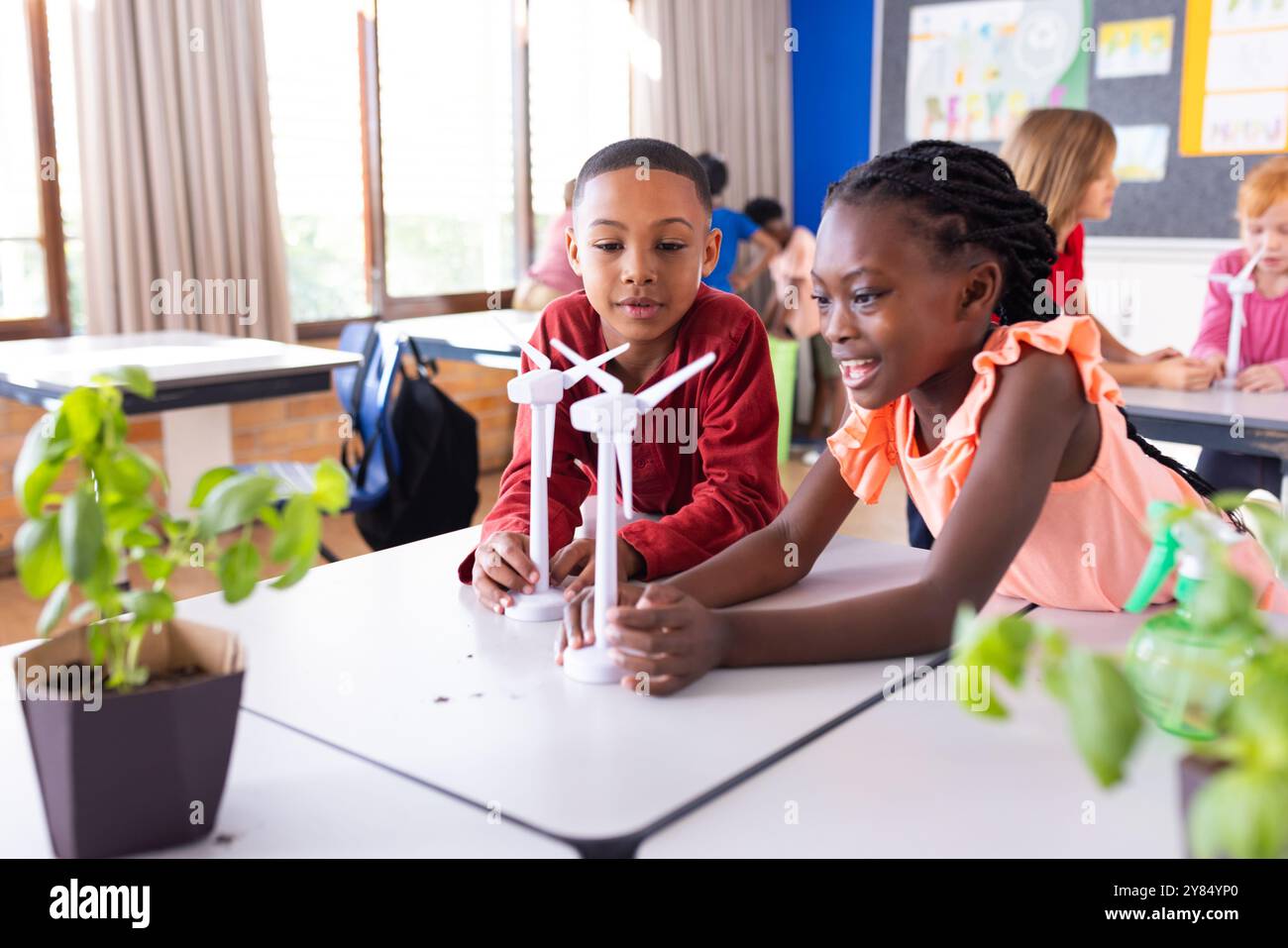 Building wind turbine models in school classroom, diverse children ...