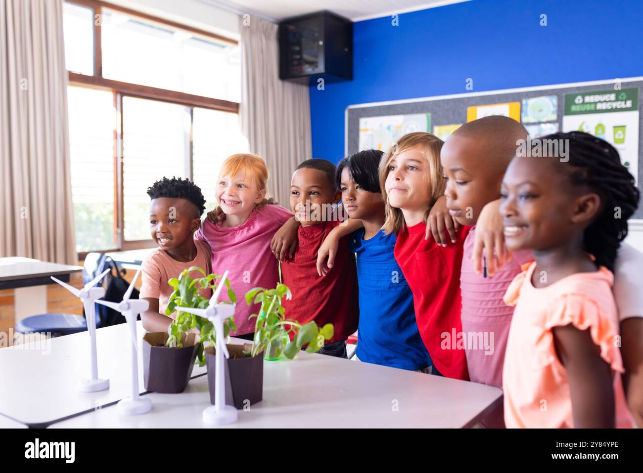 In school, diverse group of children standing together, smiling near ...