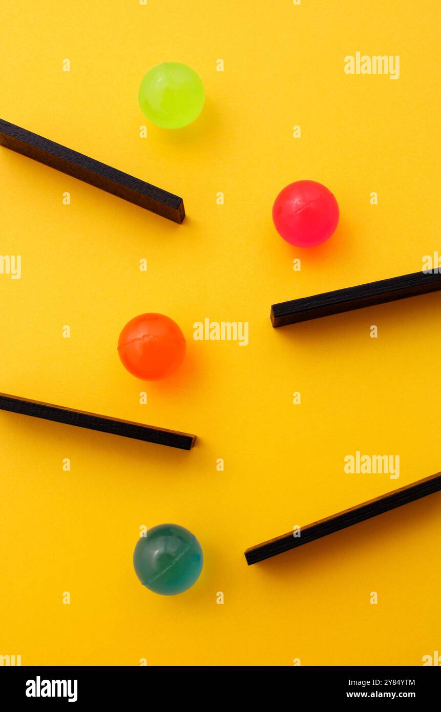 Colorful spheres falling pushing obstacles in the way Stock Photo - Alamy