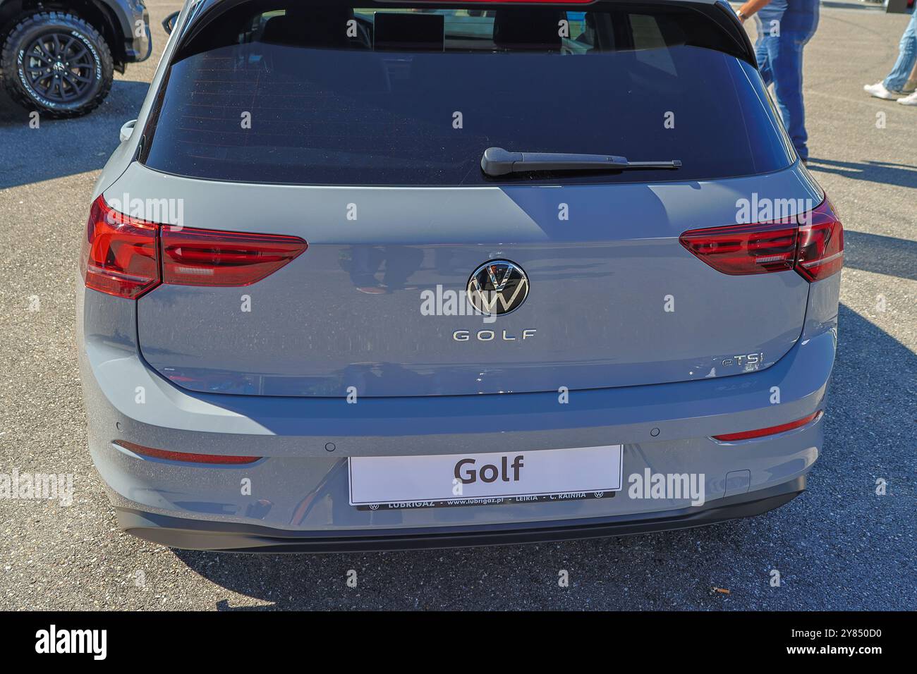 Shiny brand new metallic blue vw golf with visible vw logo on the back ...