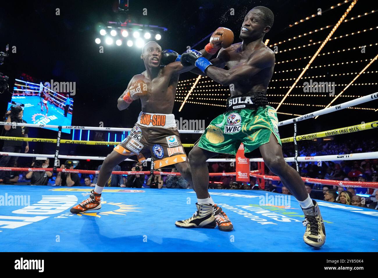 Bruce Carrington punches Uganda's Sulaiman Segawa during their ...