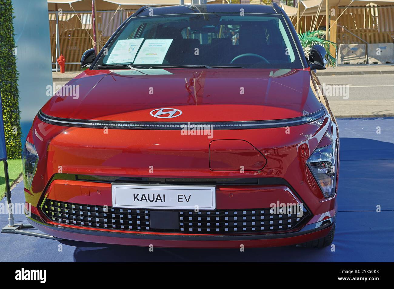 Brand new red hyundai kauai ev standing on display at a dealership or ...