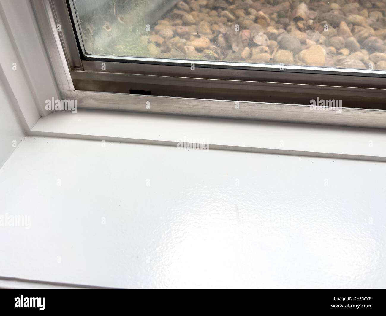 Basement Window with Metal Window Well and Rocks Stock Photo - Alamy