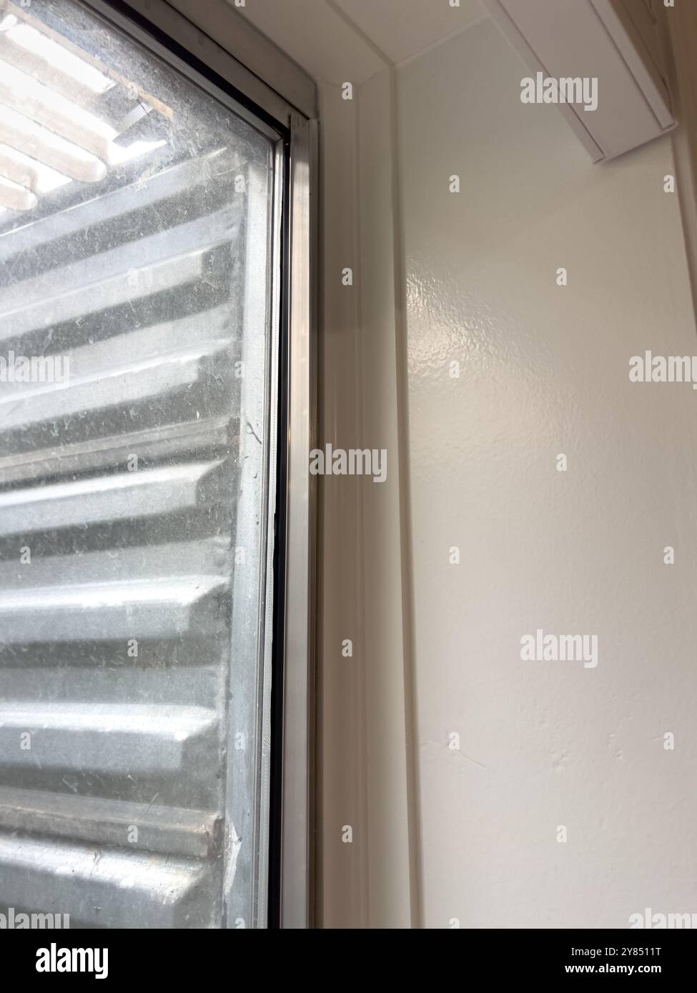 Basement Window with Metal Window Well and Rocks Stock Photo - Alamy