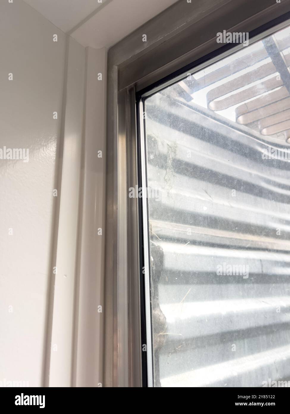 Basement Window with Metal Window Well and Rocks Stock Photo - Alamy