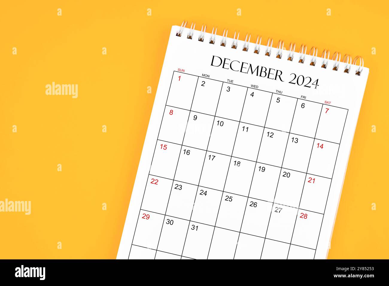 December 2024 desk calendar on yellow color background, position with ...