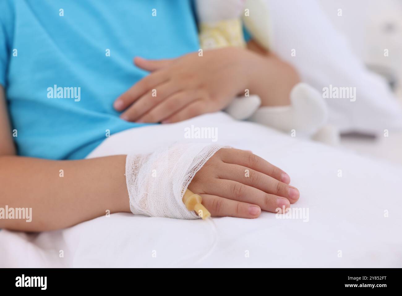 Little girl with IV drip on bed in hospital, closeup Stock Photo - Alamy