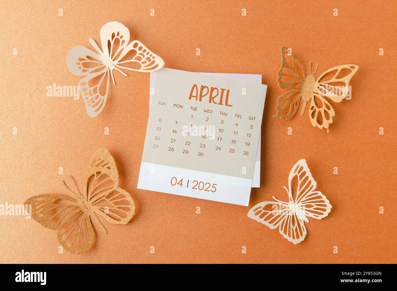 April 2025 calendar card with butterfly paper on orange color ...