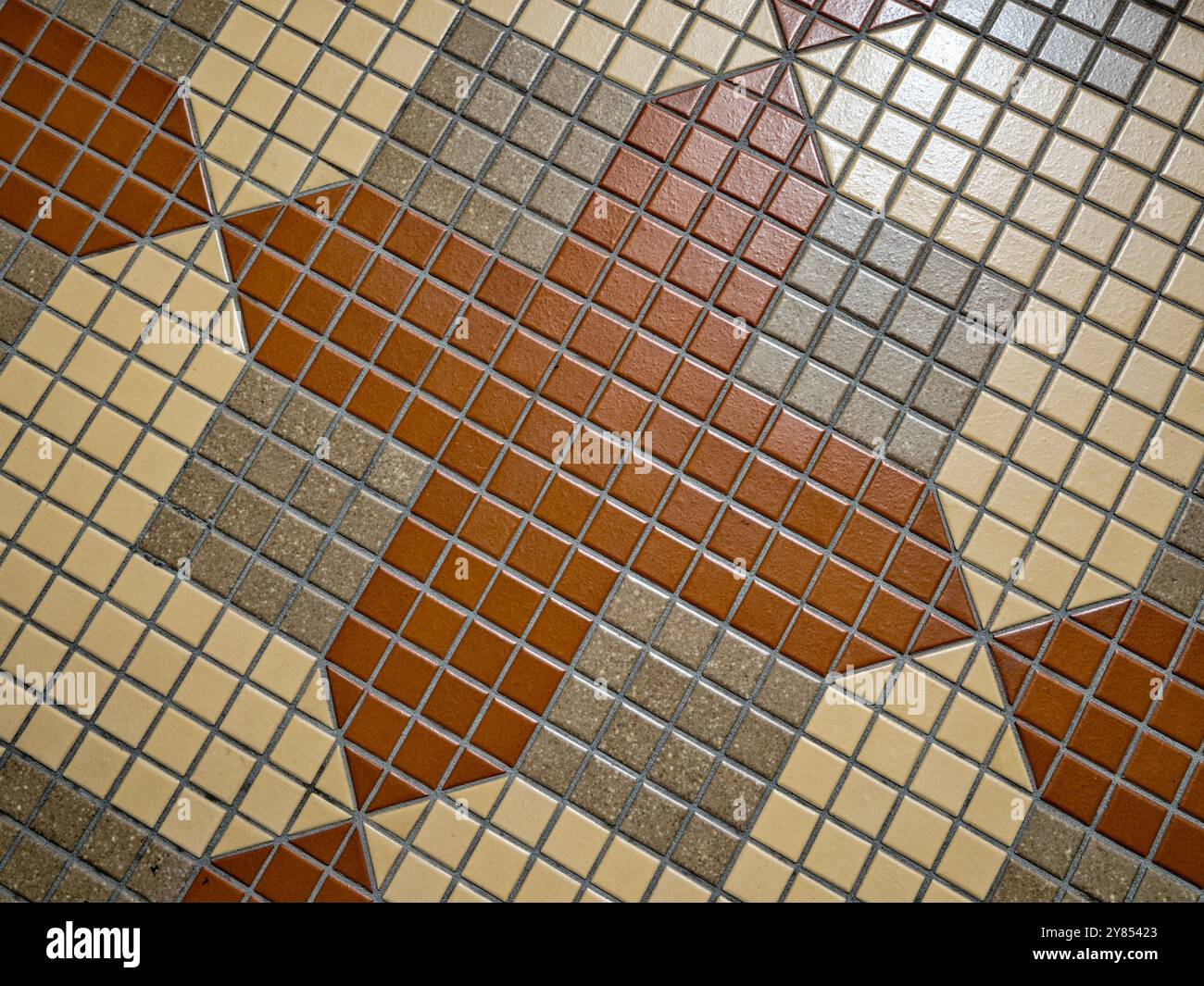 The abstract mosaic pattern in antique floor tiles looking downward ...