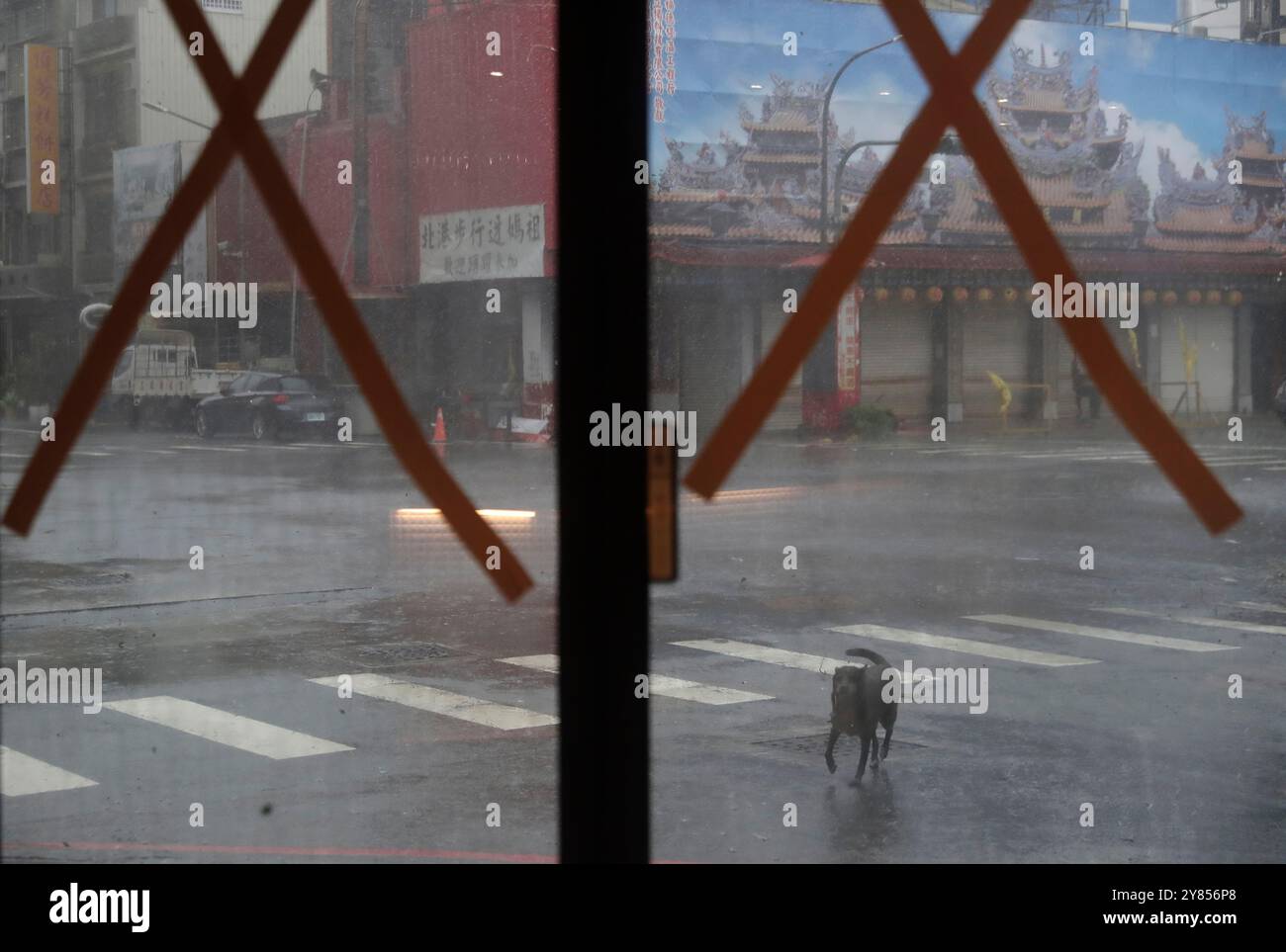 A street view from a hotel that taped the glass of its front door as ...