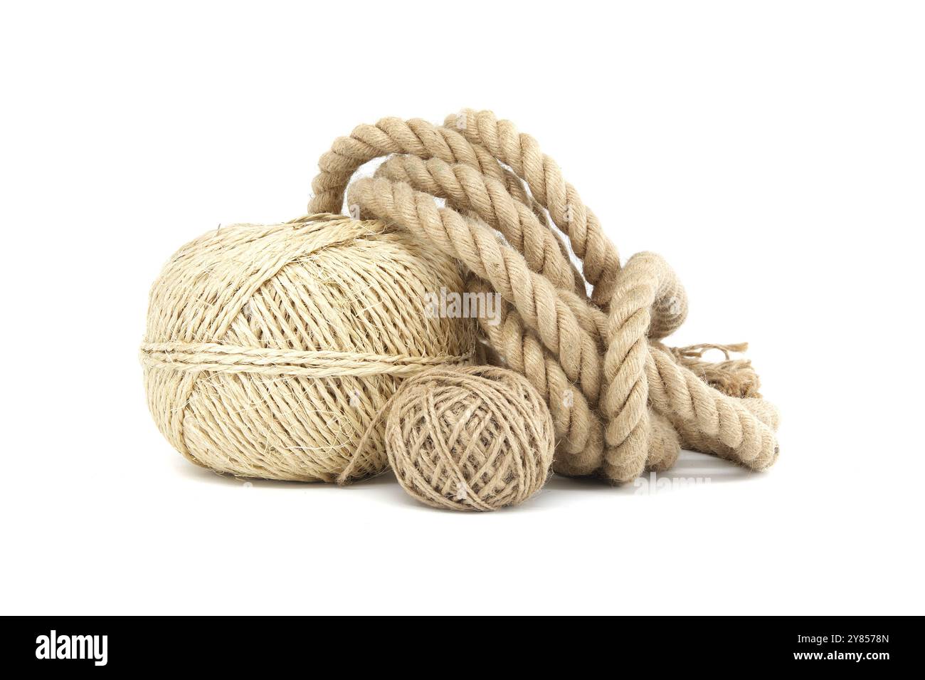 Close-up image of various natural fiber ropes and twine on a white ...