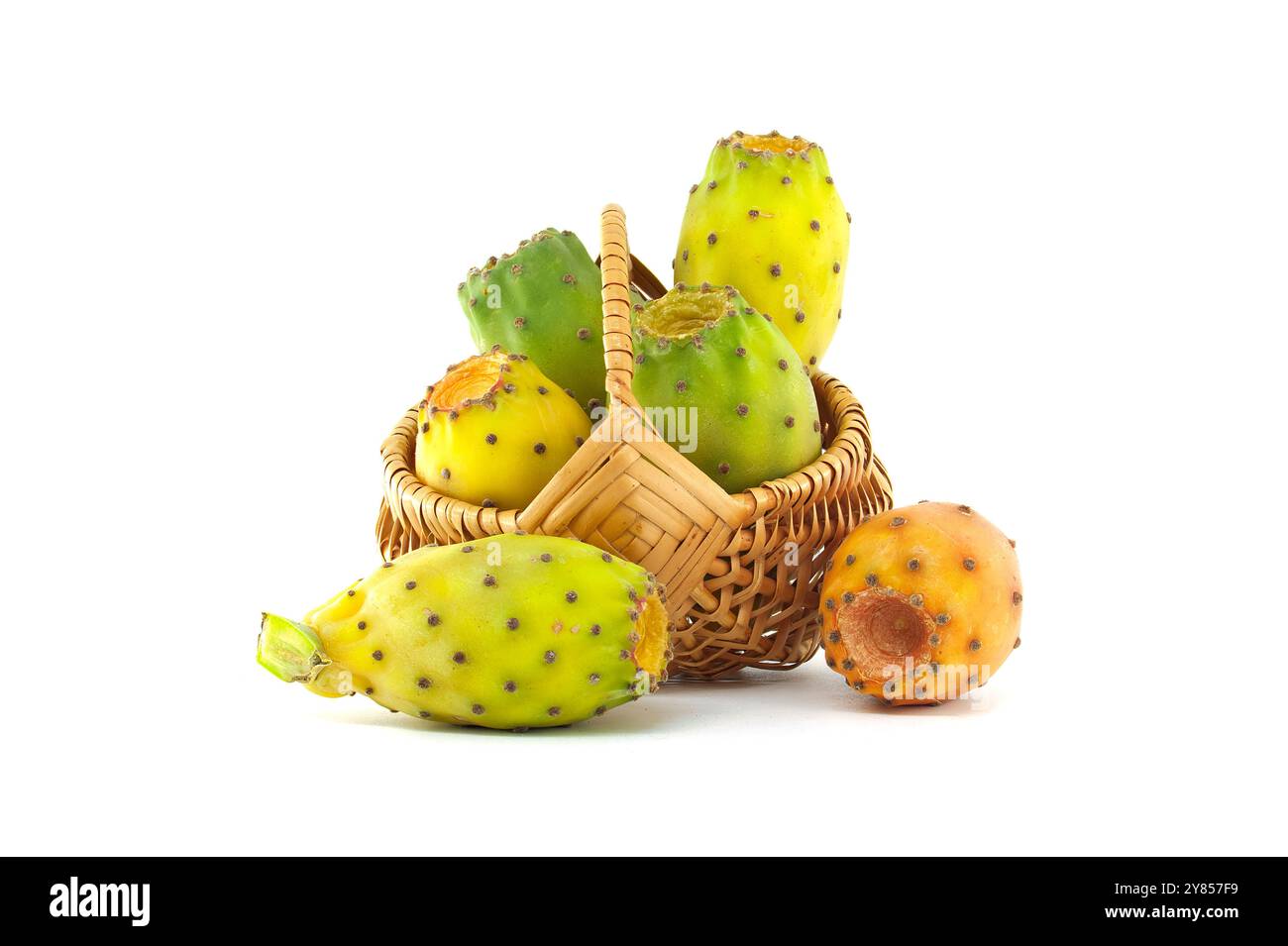 Bright prickly pears arranged in a wicker basket against a white ...