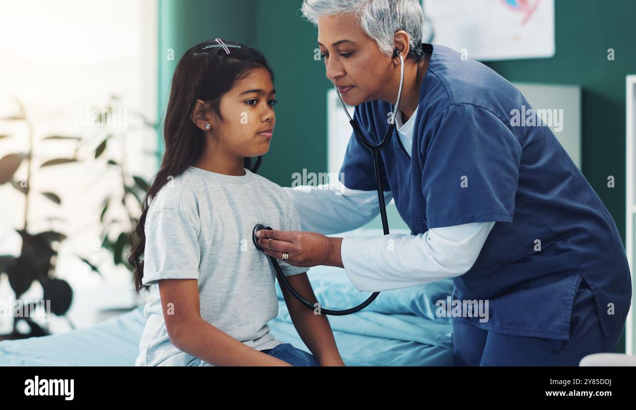 Doctor, child and lung check with breathing, listening and medical ...