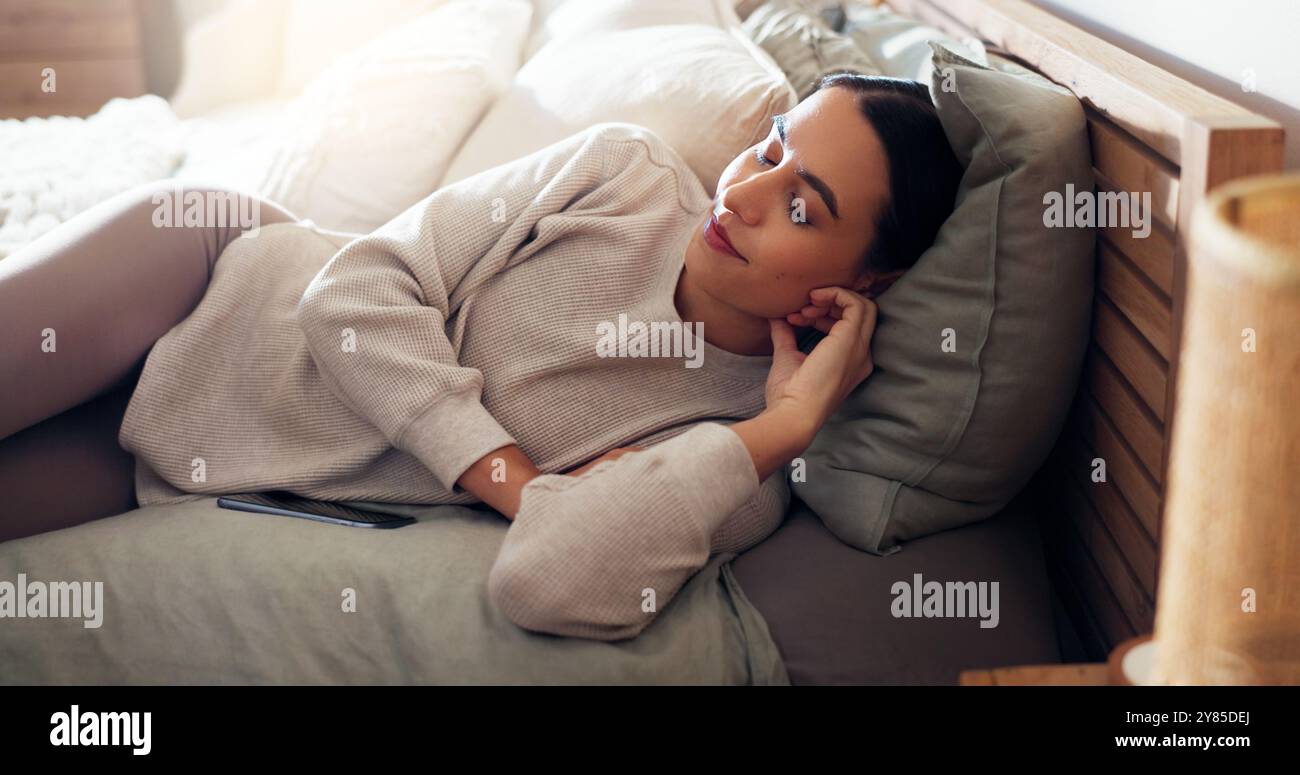 Woman, tired and sleeping on bed for nap, comfortable and afternoon ...