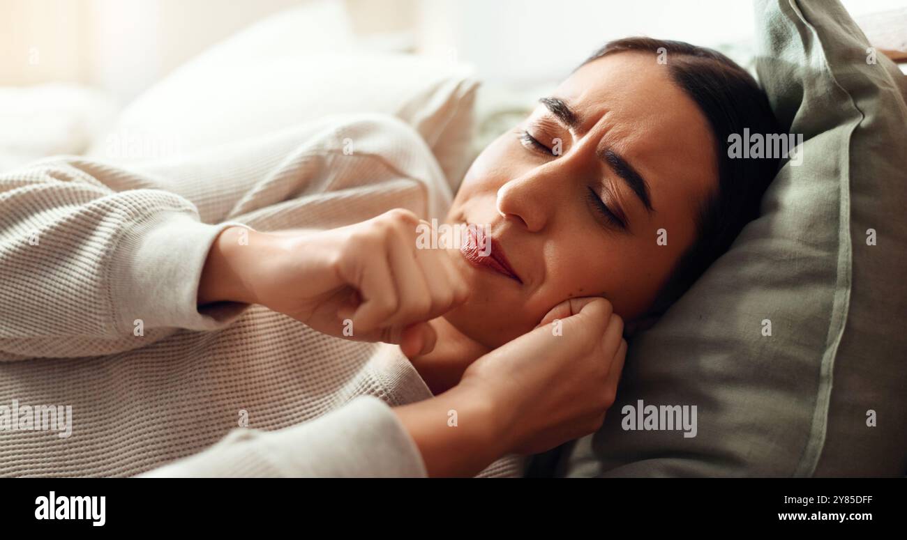 Woman, coughing and sick in home, cold influenza and laying on bed with bacteria infection ...