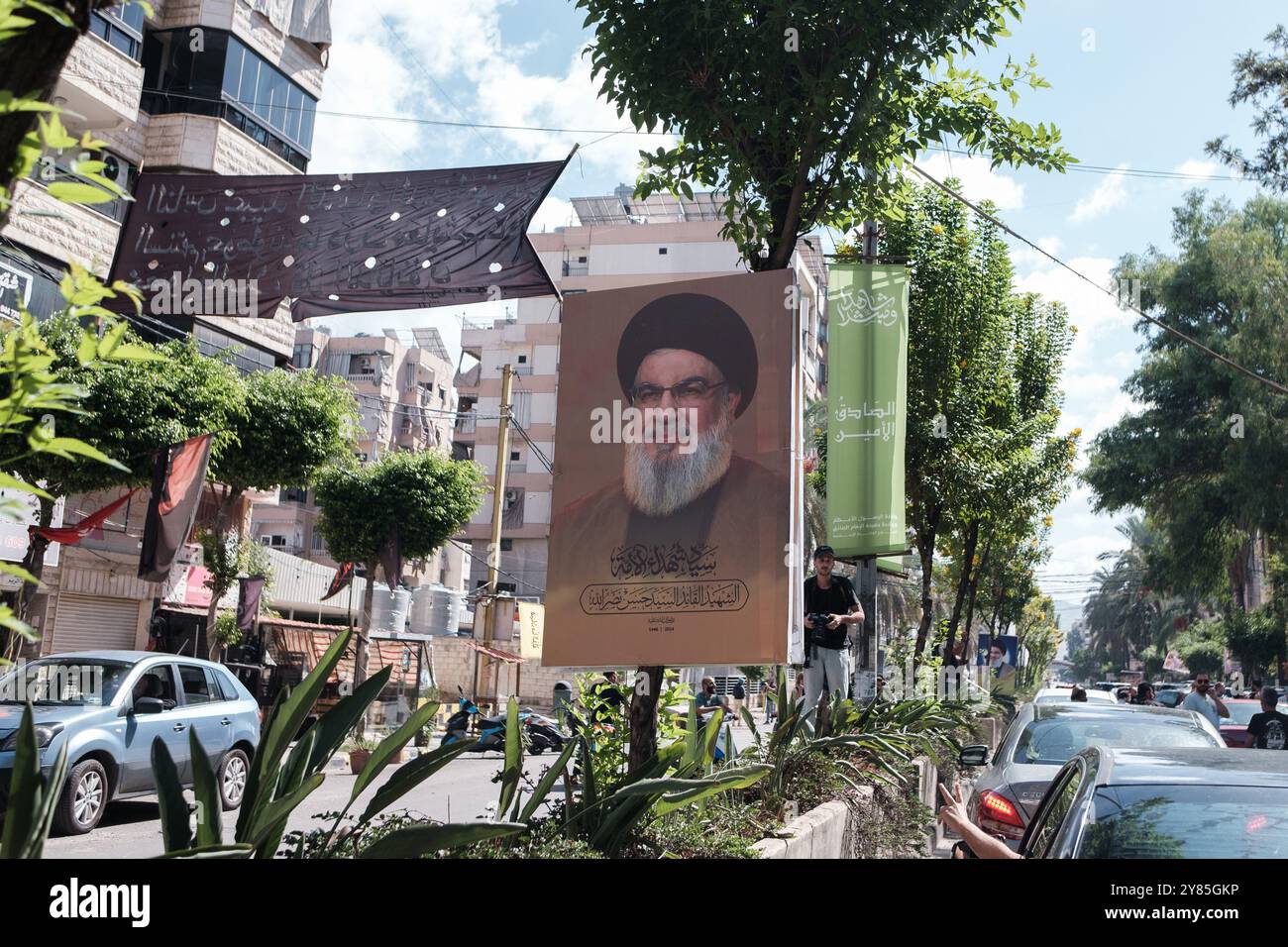 A view of a poster of Hezbollah leader Nasrallah amid destroyed ...