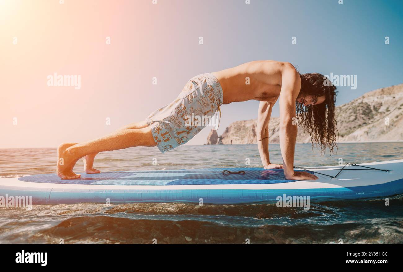Yoga Paddleboard Man Ocean - Man doing yoga on paddleboard in ocean ...