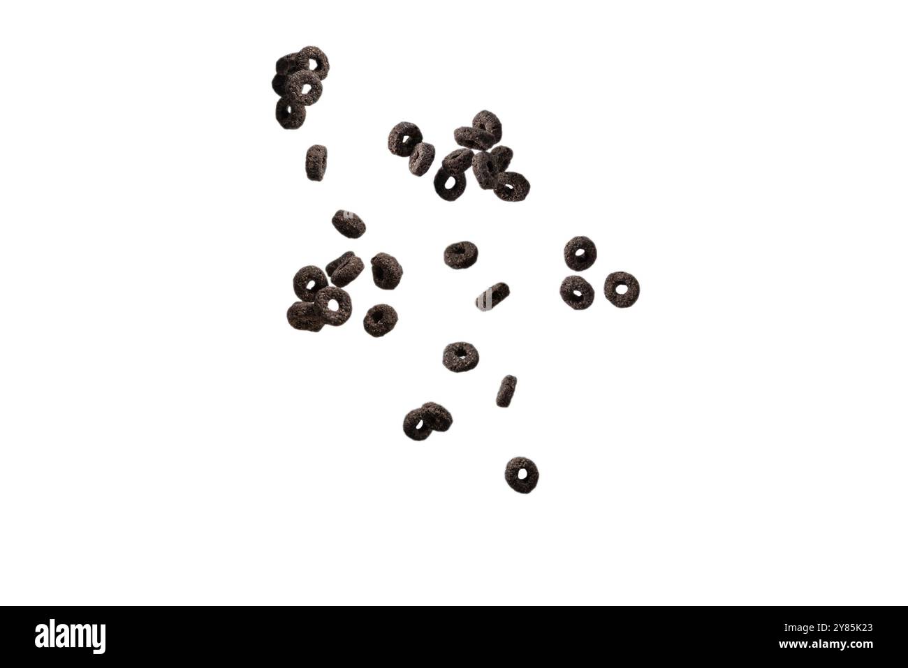 Chocolate rings cereal spill out into a bowl. Breakfast. Isolated on a ...