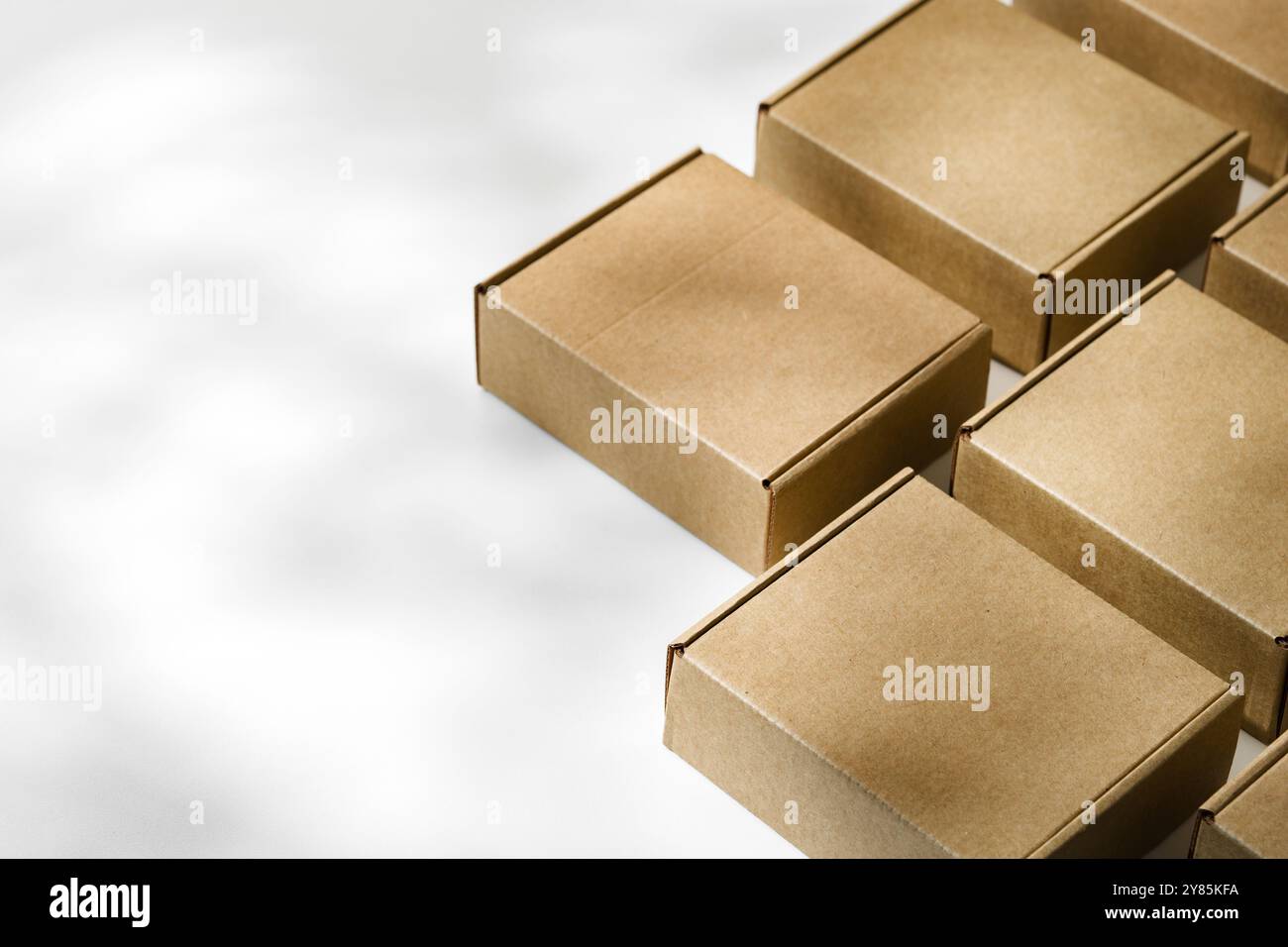 Brown cardboard boxes arranged on a neutral background in a warehouse ...