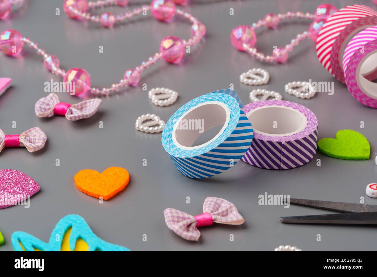 Crafting materials and tools arranged on a gray surface during a ...