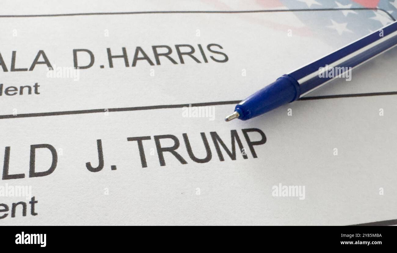 Ukraine Kyiv, September 19, 2024: A pen hovers between Donald J. Trump ...