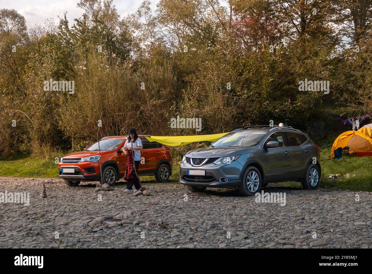 Camping Setup by the Riverbank with Cars summertime Stock Photo - Alamy