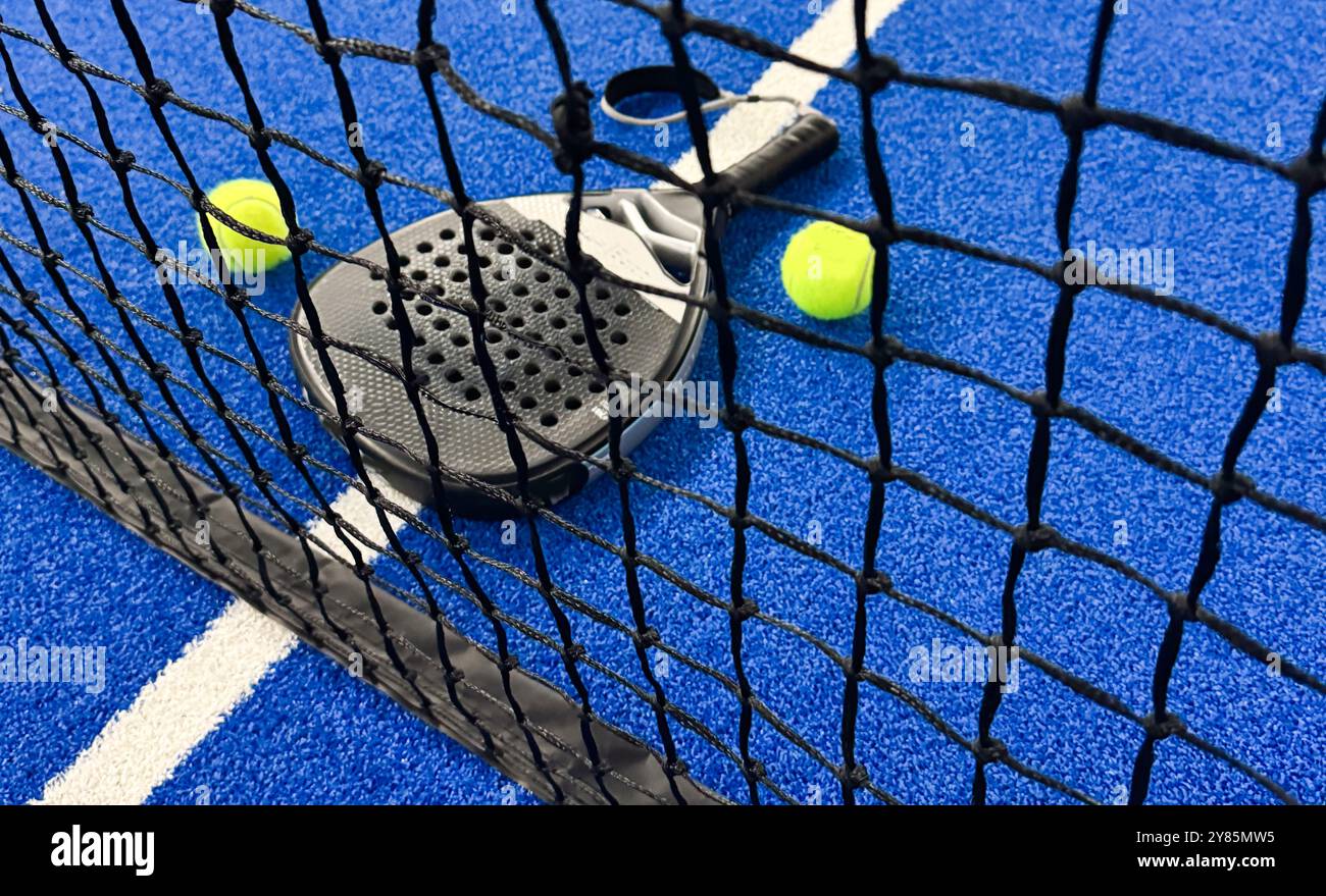 padel racket on a padel blue court with a ball Stock Photo - Alamy