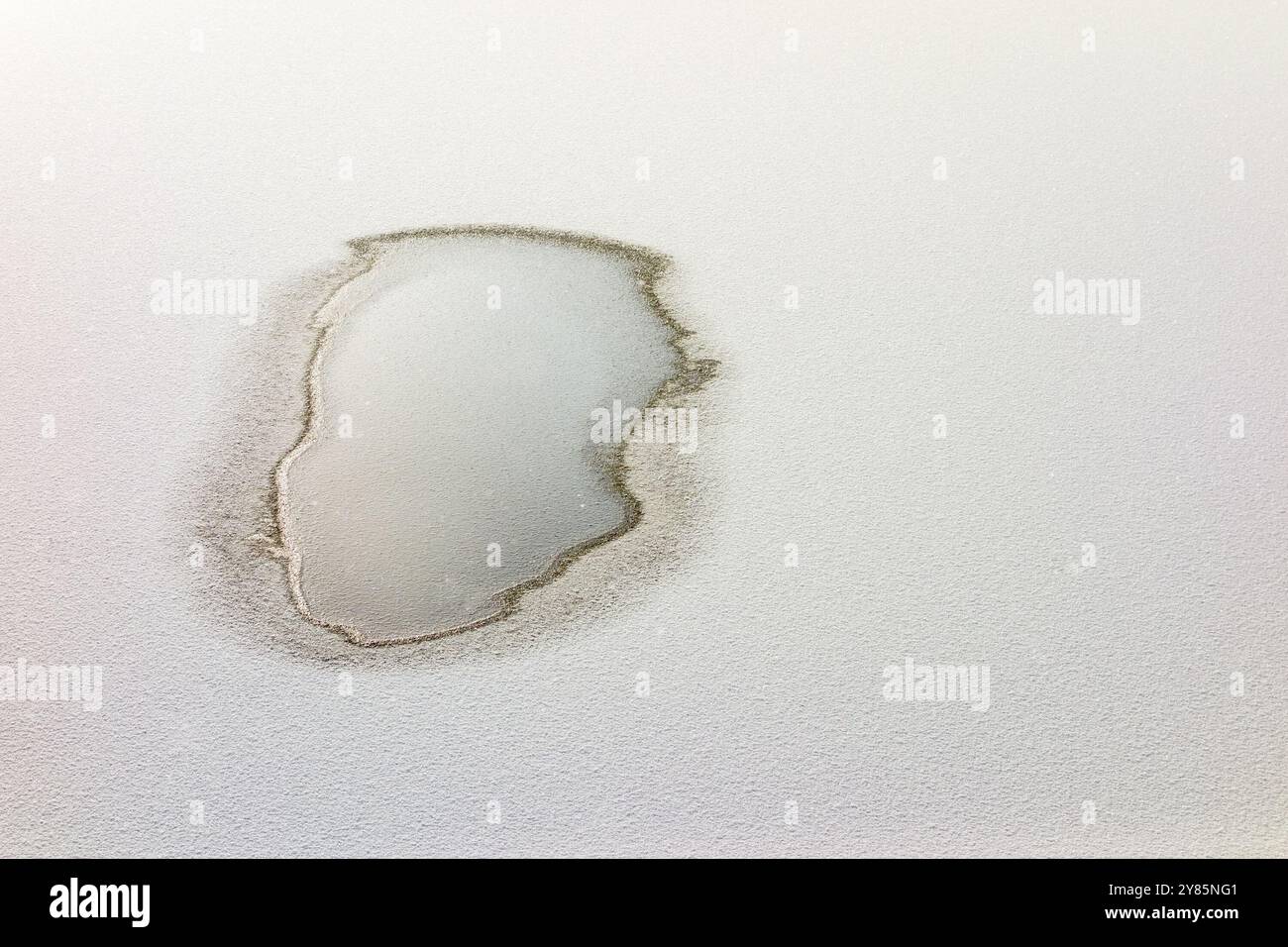 Melted water puddle on the lake Stock Photo - Alamy