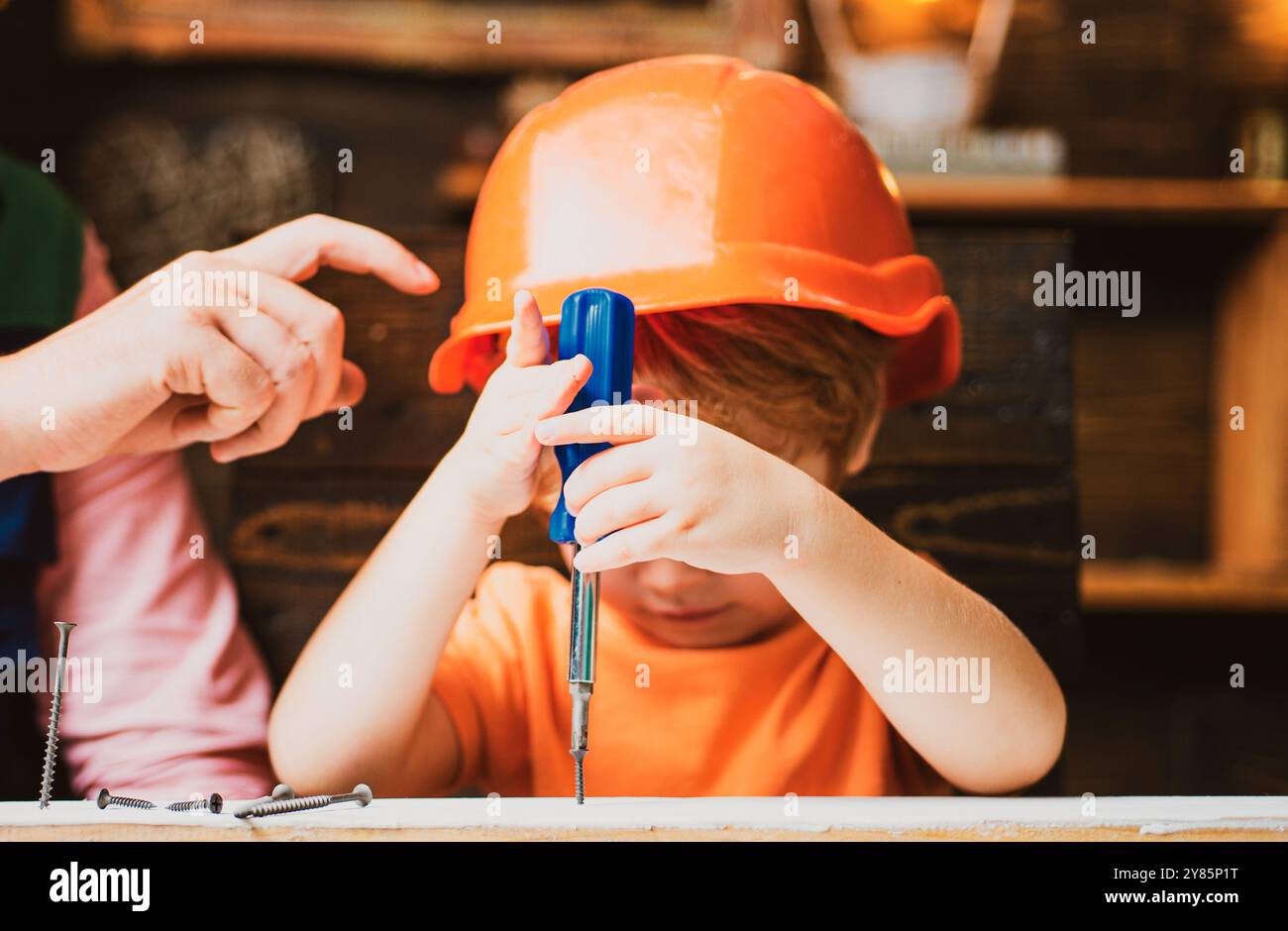 Child with a screw-driver. Kid boy using a screw driver. Early ...