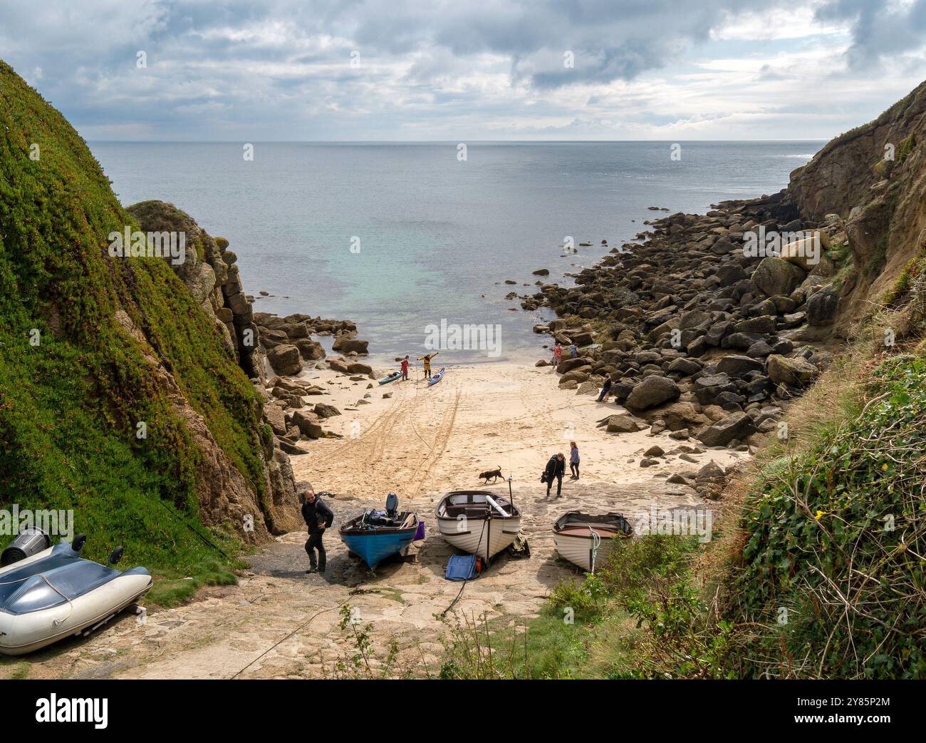 Boats on the steep slipway above sandy beach at Porthgwarra Cove ...