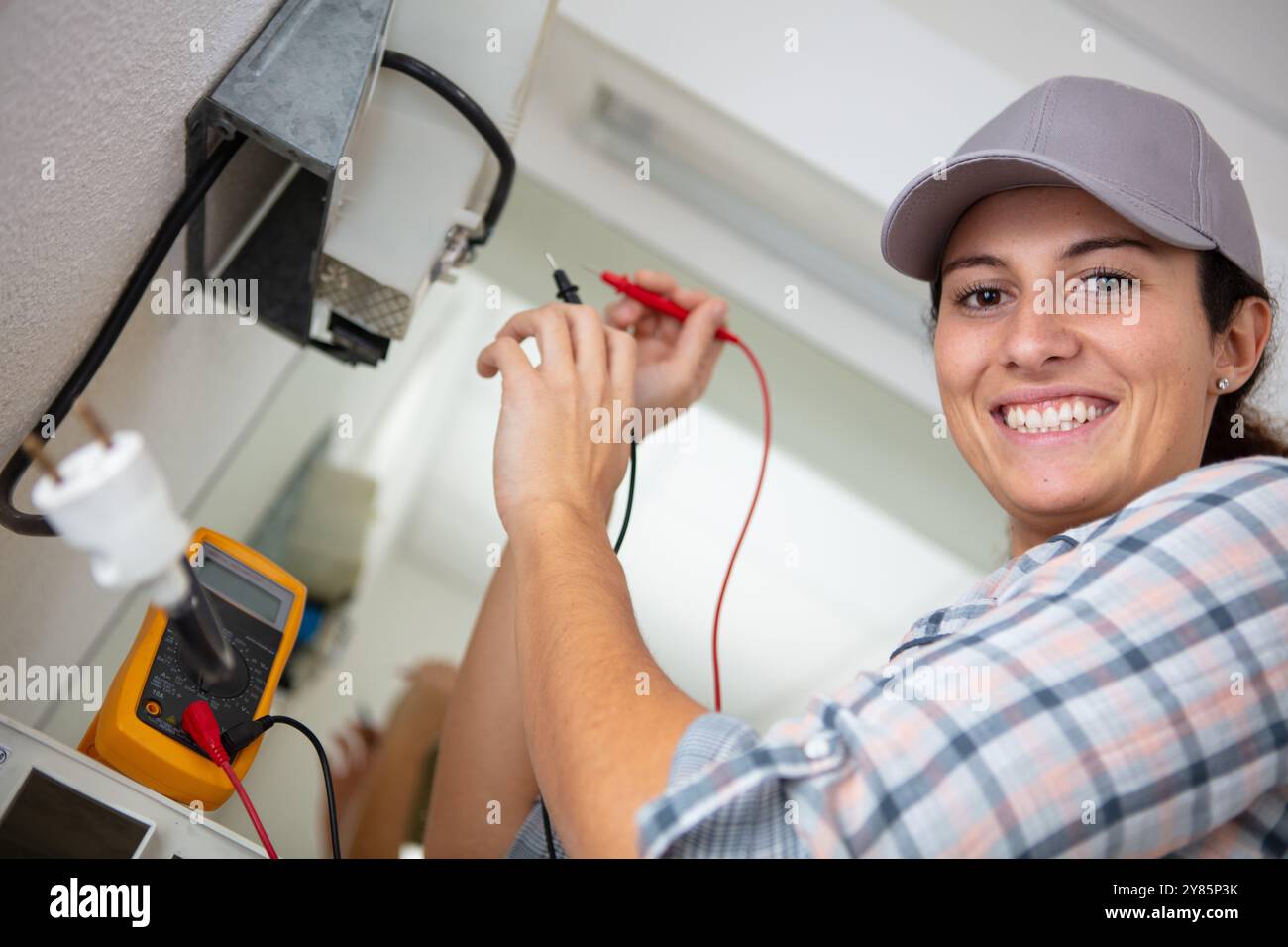 female electrician using multimeter to test an appliance Stock Photo ...